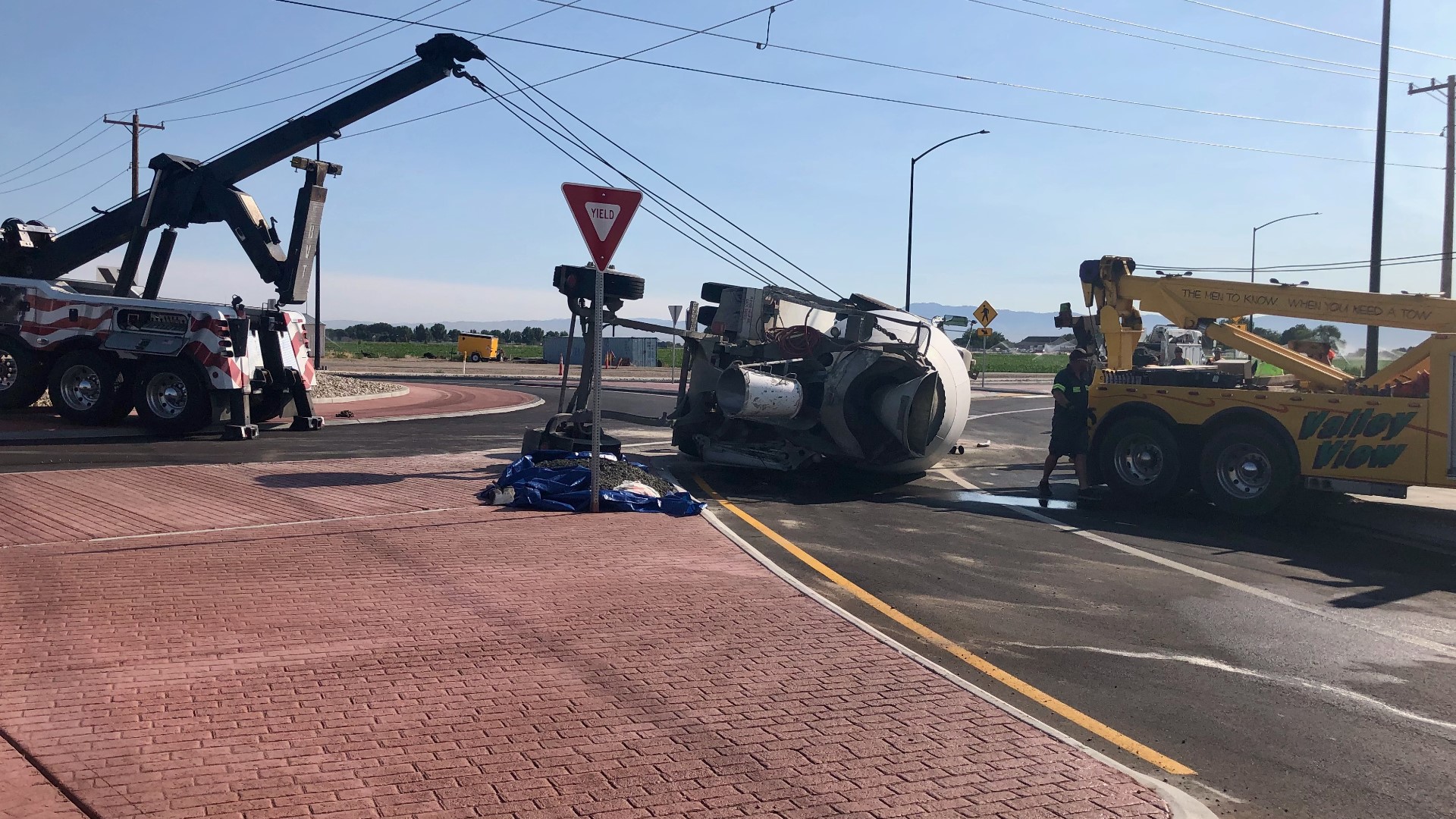 Driver taken to hospital after truck overturns in roundabout near ...